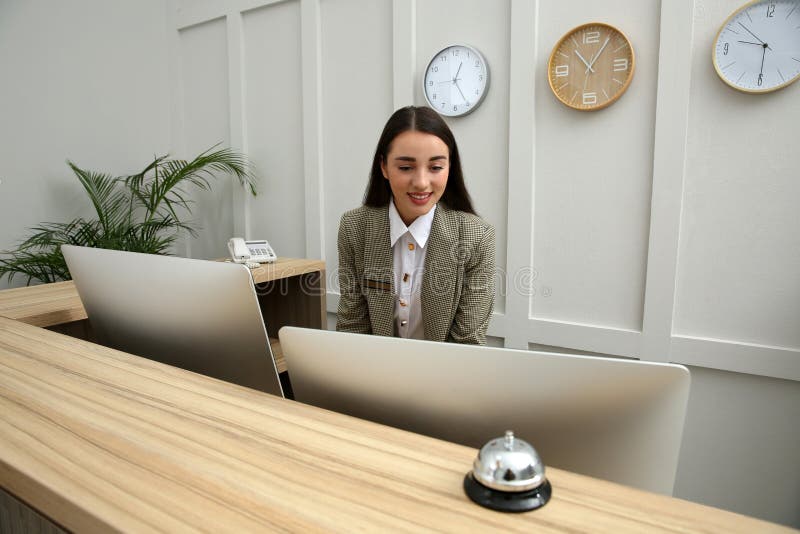 Beautiful Receptionist Working at Counter in Hotel Stock Photo - Image ...