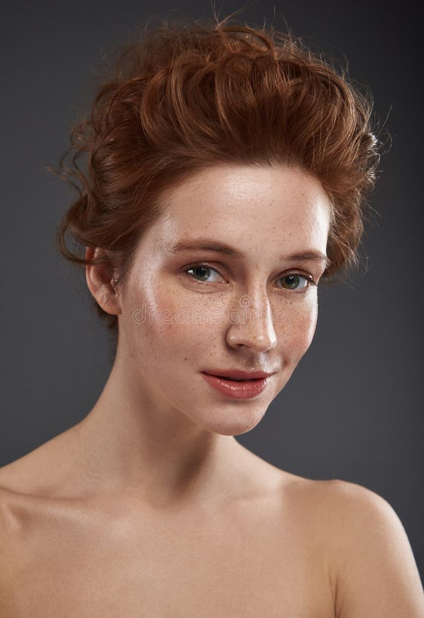Beautiful Red Haired Girl With Freckles Posing Against Gray Background