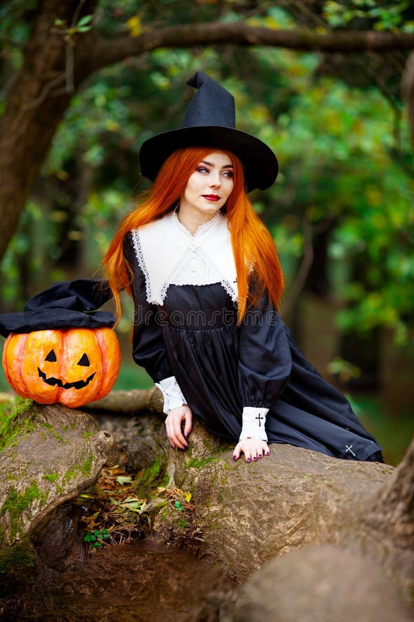 Beautiful Red-haired Girl in the Image of a Witch in a Halloween ...