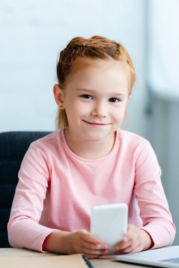 Beautiful Redhead Child Using Smartphone and Smiling Stock Photo ...