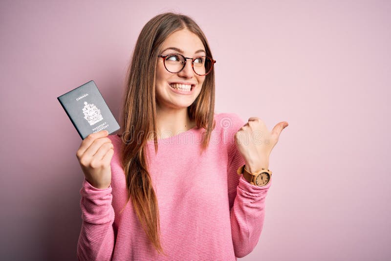 Beautiful Redhead Tourist Woman Holding Canadian Canada Passport Over Pink Bakcground Pointing 9940