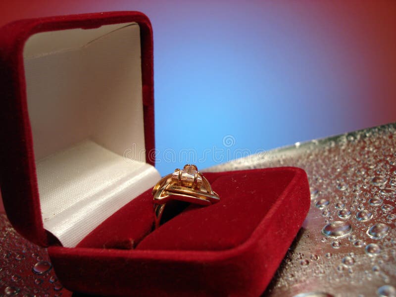 Beautiful Ring in Box on Blue and Silver Background with Drop of Stock ...