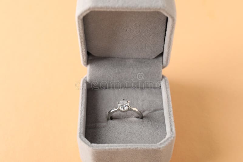 Beautiful Ring with Gemstone in Box on Beige Background, Closeup Stock ...