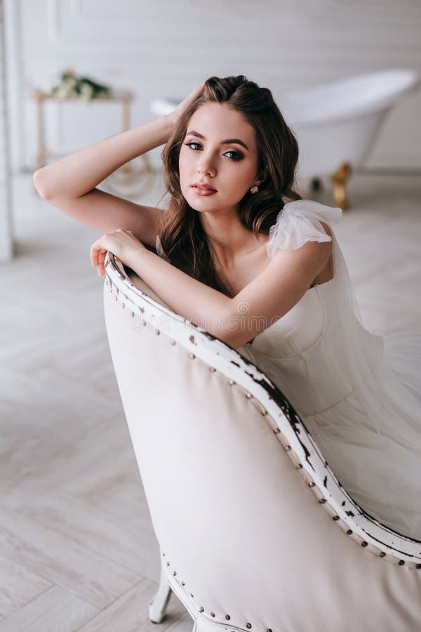 Beautiful Romantic Bride in Wedding Dress Sitting in Studio Stock Image ...