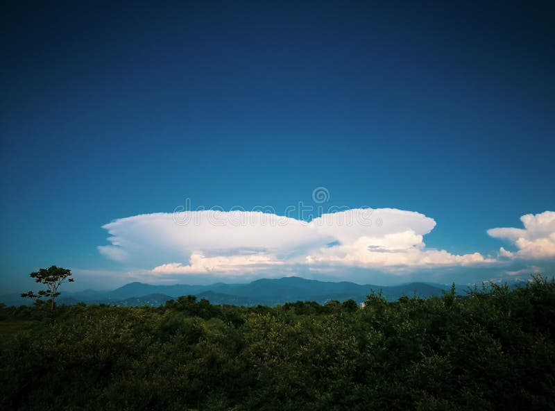 Beautiful Round Clouds Over the Mountains, Green Forest in the ...