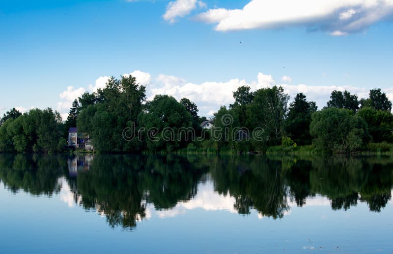 Beautiful Russian Landscape Reflected in the Lake. Green Trees and Blue ...