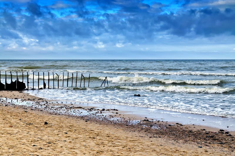 Beautiful Sandy Beach and the Old Rusty Breakwater Stock Image - Image ...