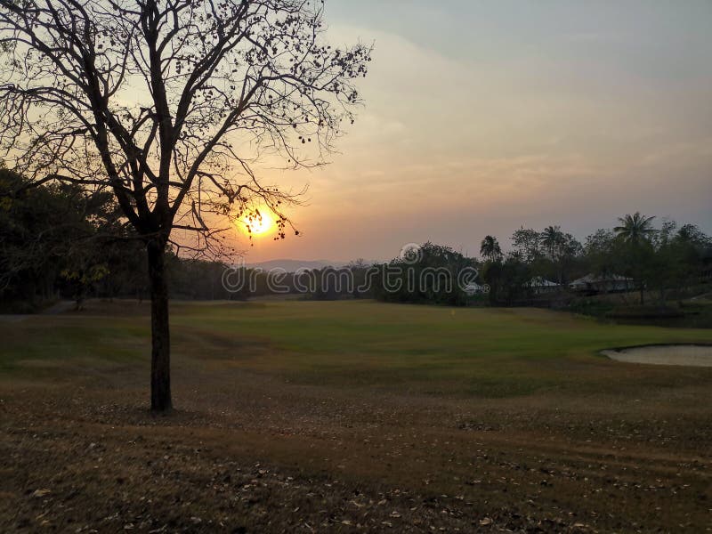 Beautiful Scene of Big Sunset at Green Grass of Golf Course Stock Image ...