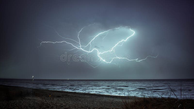 Beautiful Scene of Lightning in the Gray Sky Over the Sea Stock Photo ...
