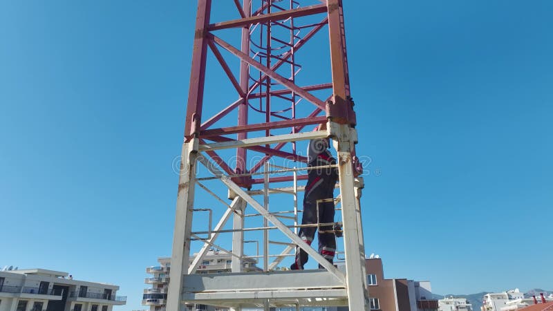 Aerial View: Crane Assembly in Progress As the Operator Climbs Ladders ...
