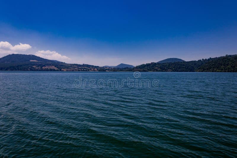 Beautiful Scenery of a Calm Lake and Land Fully Covered with Trees ...