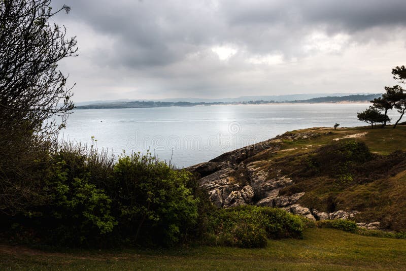 Beautiful Scenery of Greenery on Cliff with the Sea and Cloudy Sky in ...