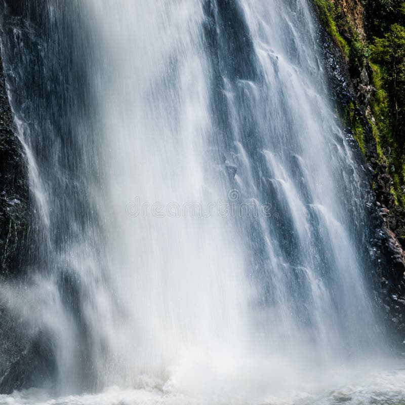 Beautiful Scenery of a Powerful Waterfall Flowing through a Cliff into ...