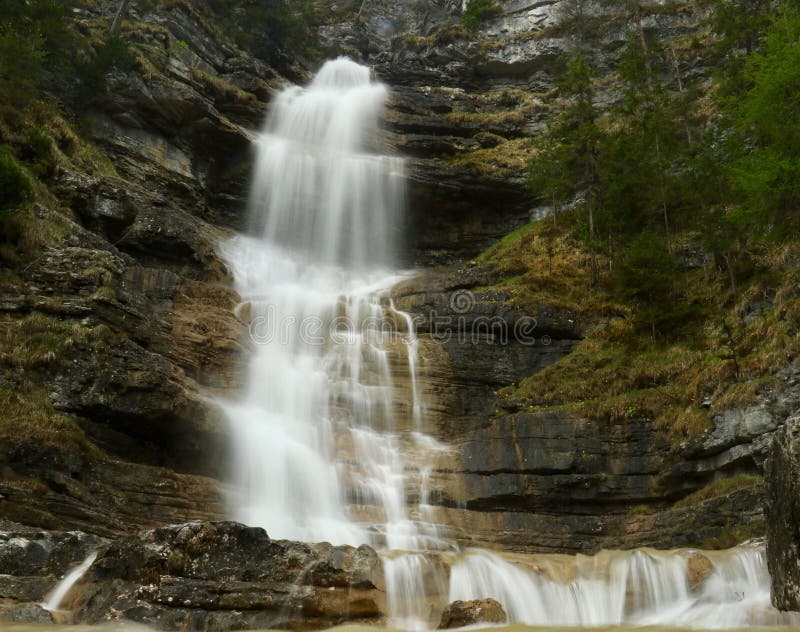 Beautiful Scenery of a Powerful Waterfall Flowing through Rocky Cliffs ...