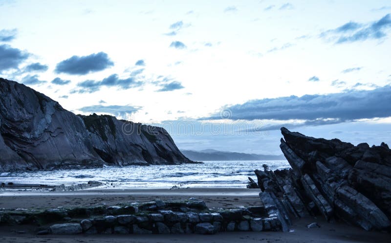 Beautiful Scenery of Rock Formations by the Sea Under a Cloudy Sky ...