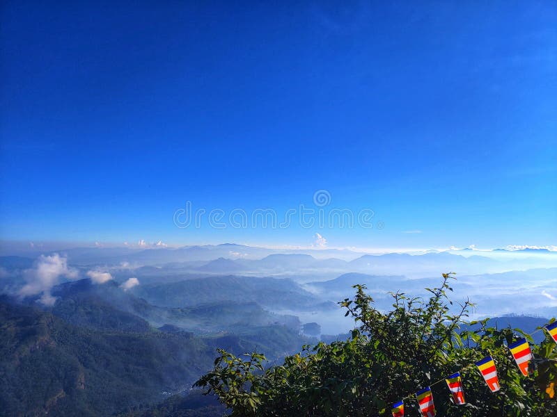 Beautiful Scenery of Rocky Mountains Enveloped in Clouds in Blue Sky ...