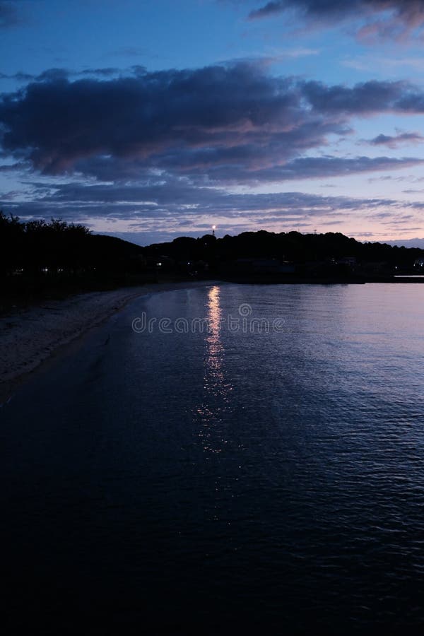 Beautiful Scenery of the Sea at Sunset with Dark Clouds and Reflection ...