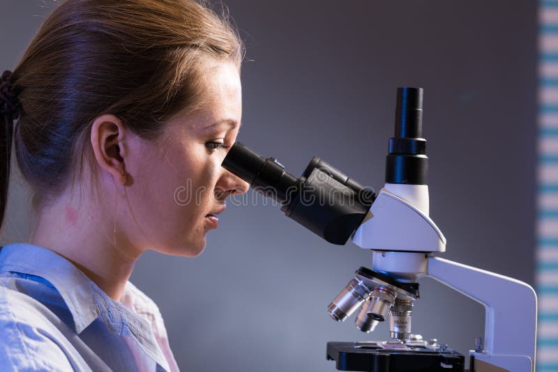Beautiful Science Student Looking into a Microscope in a Laboratory ...
