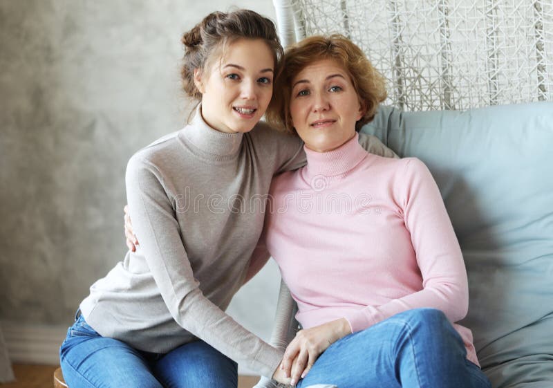 Beautiful Senior Mom And Her Adult Daughter Are Hugging Looking At
