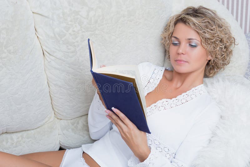 Beautiful Blonde Girl Reading A Book Lying On Stock Image Image Of