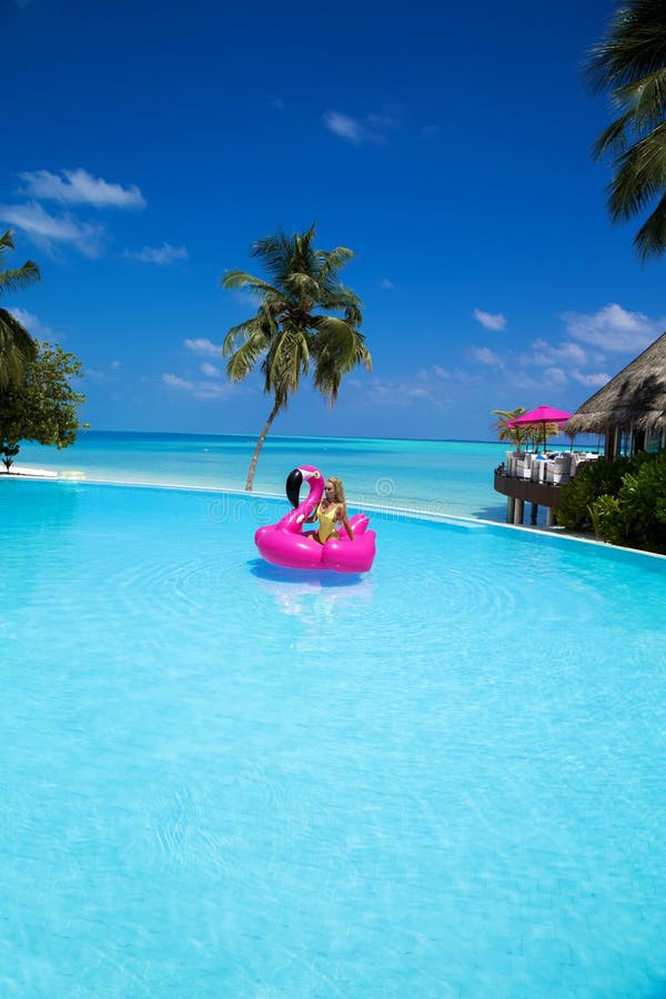 Beautiful Tanned Woman Bikini Model On Pink Flamingo In Pool Young