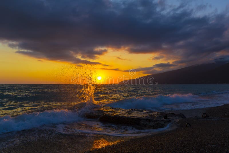 Beautiful Shoreline Scene With Waves At Sunset Beams Stock Photo ...