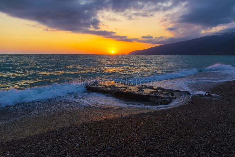 Beautiful Shoreline Scene with Waves at Sunset Beams Stock Image ...