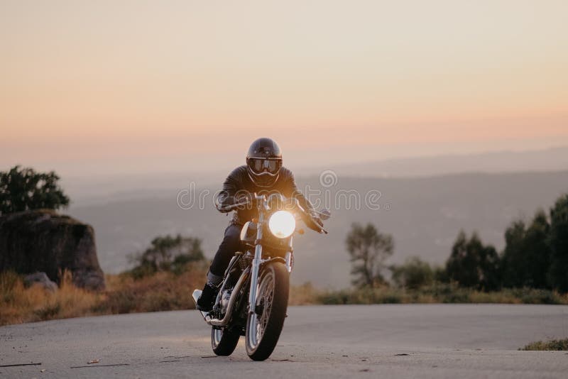 Beautiful Shot of a Biker Driving a Motorcycle during the Sunset Stock ...