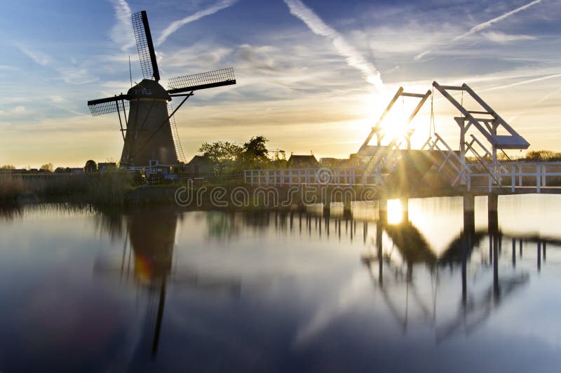 Beautiful Shot of a Farm with a Bridge and a Windmill Under a Blue ...