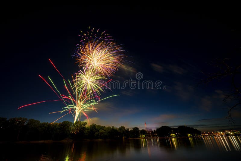 Beautiful Shot of Glowing Exploding Fireworks in a Night Sky Over a ... Beautiful Shot of Glowing Exploding Fireworks in a Night Sky Over a ...