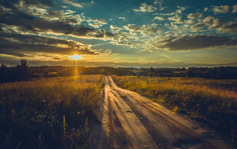 Sunset and Path through a Meadow Stock Photo - Image of mysterious ...