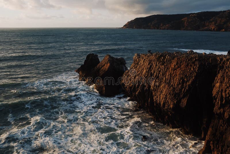 Beautiful Shot of Rocks at Sunset with the Ocean in the Background ...