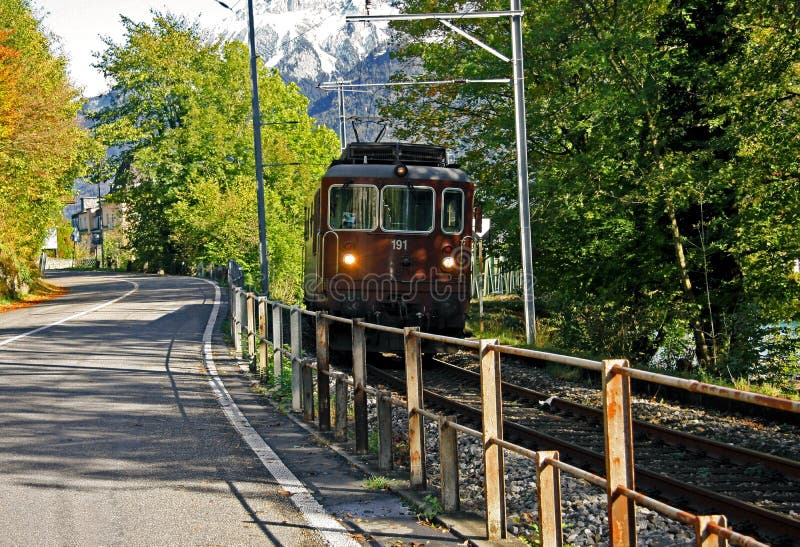Beautiful Shot of a Running Train on a Rail beside a Road Around Trees ...