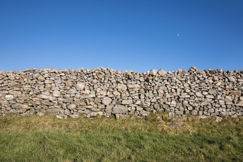 Beautiful Shot of Stone Wall in a Green Field Under a Clear Sky Stock ...