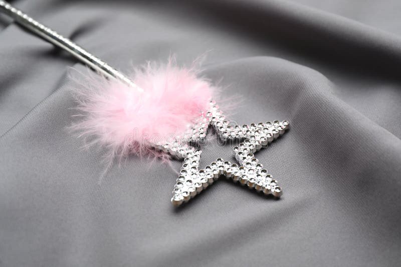 Beautiful Silver Magic Wand with Feather on Grey Fabric, Closeup Stock ...
