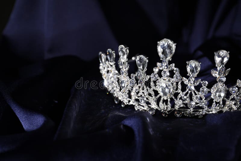 Beautiful Silver Tiara with Diamonds on Dark Blue Cloth. Space for Text ...