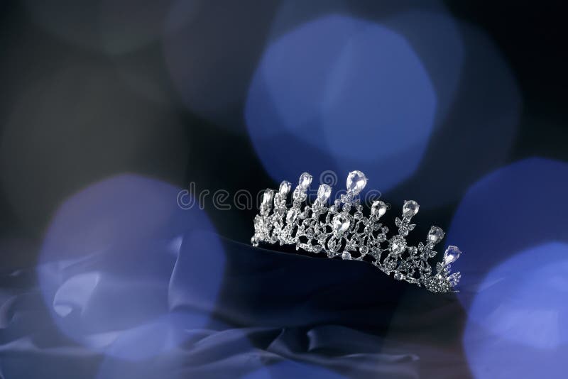 Beautiful Silver Tiara with Diamonds on Dark Cloth Against Blurred ...