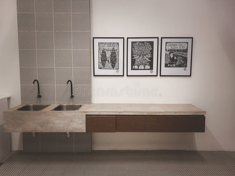 A Beautiful Sink with Three Picture on the White Wall Stock Image ...