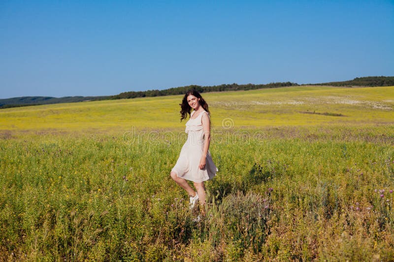 Beautiful Young Woman Walking in Field Stock Photo - Image of dawn ...