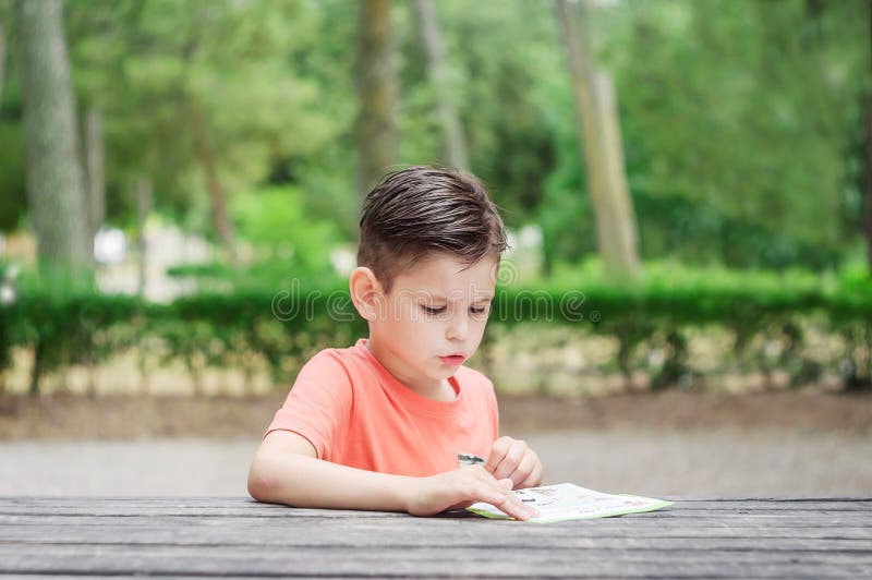 A Beautiful and Smart Boy Learning To Read. Stock Photo - Image of ...