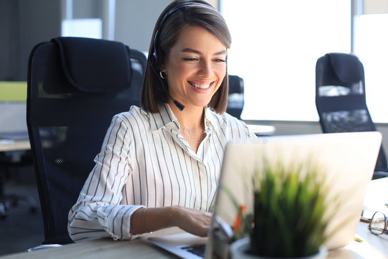 Beautiful Smiling Call Center Worker in Headphones is Working at Modern ...