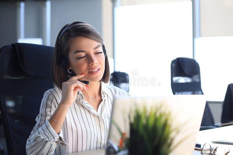 Beautiful Smiling Call Center Worker in Headphones is Working at Modern ...
