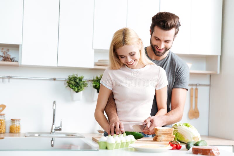 Beautiful Smiling Couple Cooking Together in a Modern Kitchen Stock ...