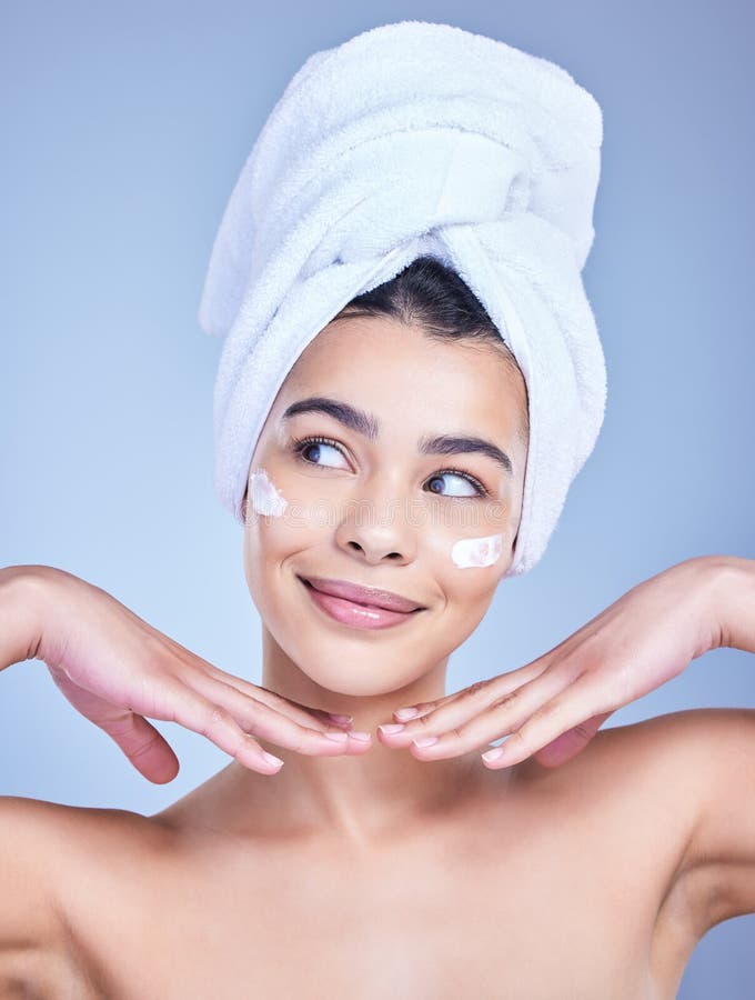 A Beautiful Smiling Happy Mixed Race Woman Applying Cream To Her Face Hispanic Model With