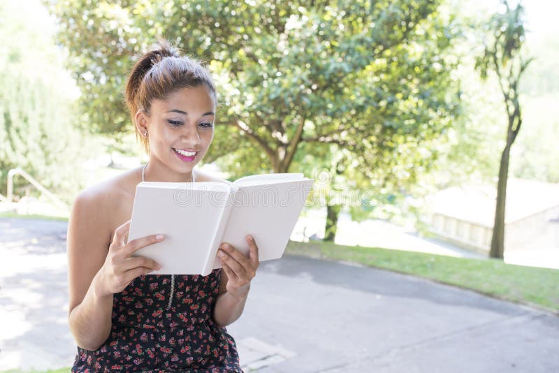 Beautiful Smiling Woman Reading Book in the Park. Stock Image - Image ...