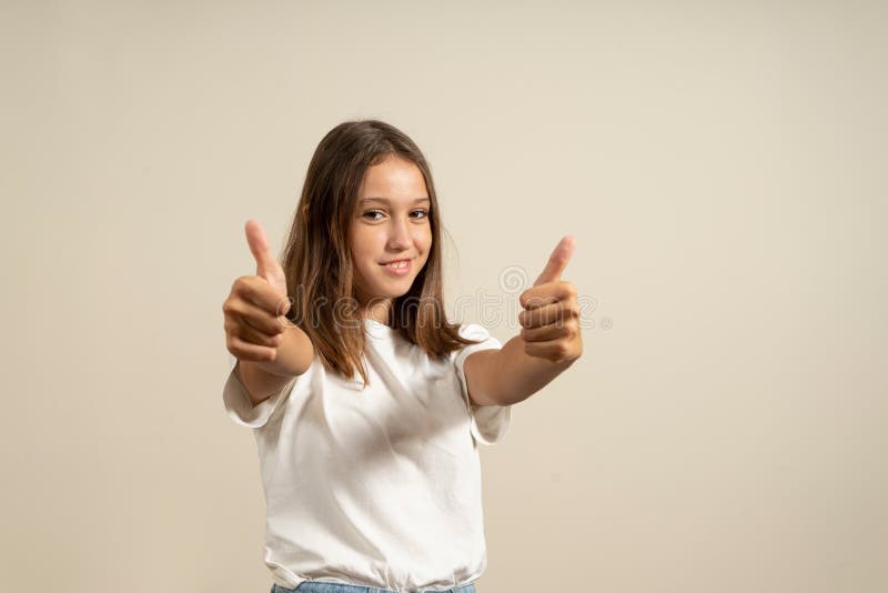 Beautiful Smiling Young Woman Giving Thumbs Up Isolated on Beige ... Beautiful Smiling Young Woman Giving Thumbs Up Isolated on Beige ...