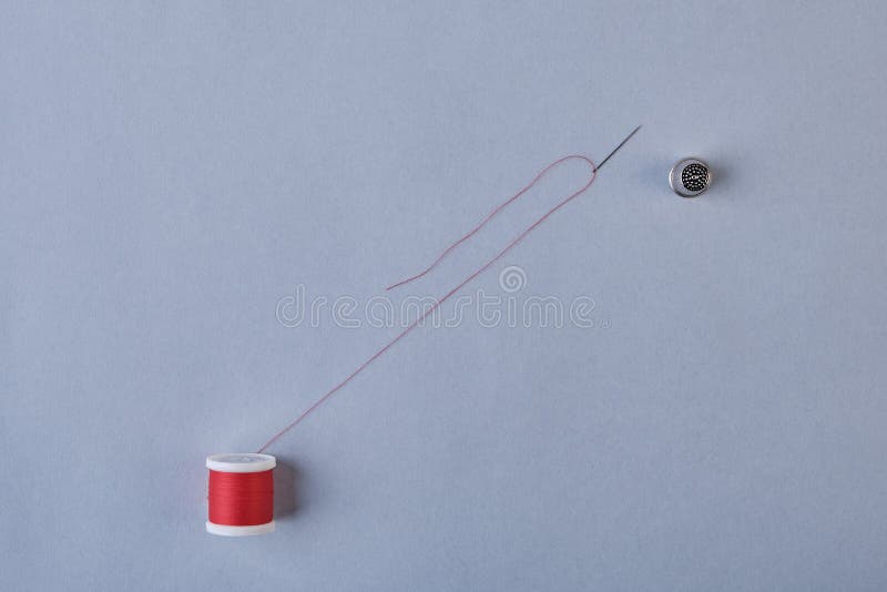 A Beautiful Spool of Bright Red Sewing Thread is Unwound and Threaded ...