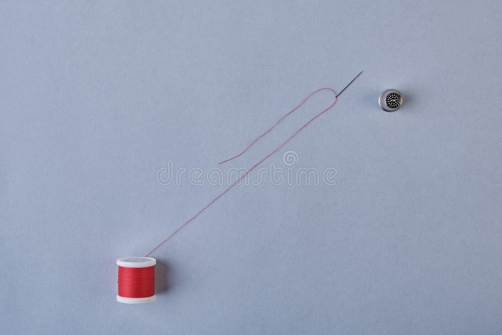 A Beautiful Spool of Bright Red Sewing Thread is Unwound and Threaded ...
