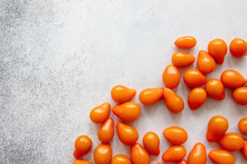 Small Orange Tomatoes on a Grey Table Stock Photo - Image of eating ...