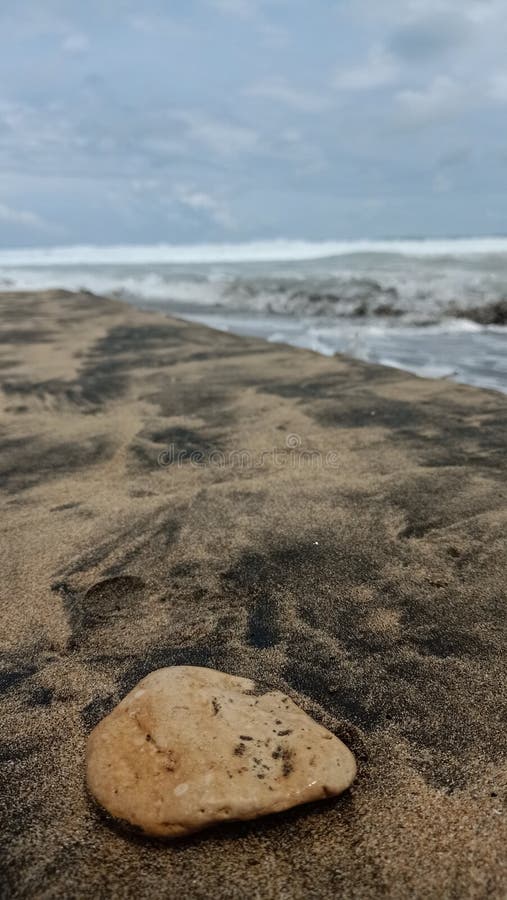 A Beautiful Stone on the Beach Sands Stock Photo - Image of beautiful ...